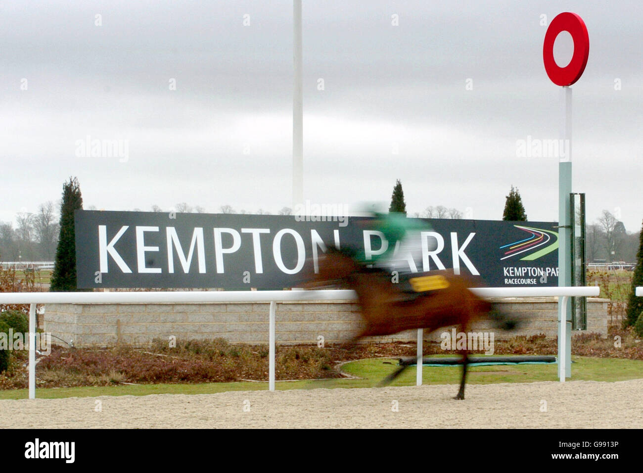 Horses flash past the finishing post at kempton park hi-res stock ...