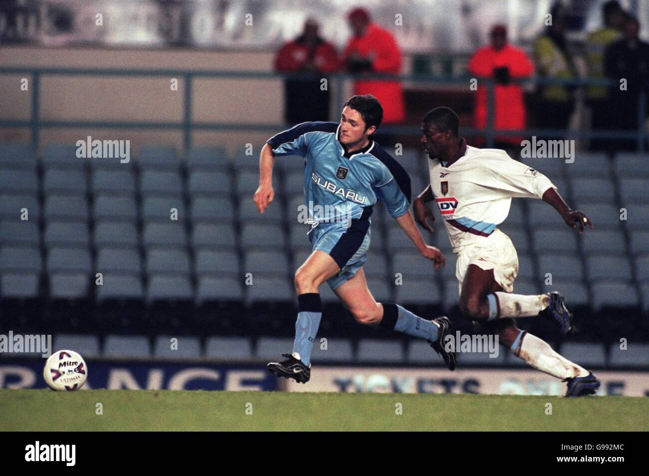 Coventry City's Robbie Keane (left) tries to get away from Aston Villa ...