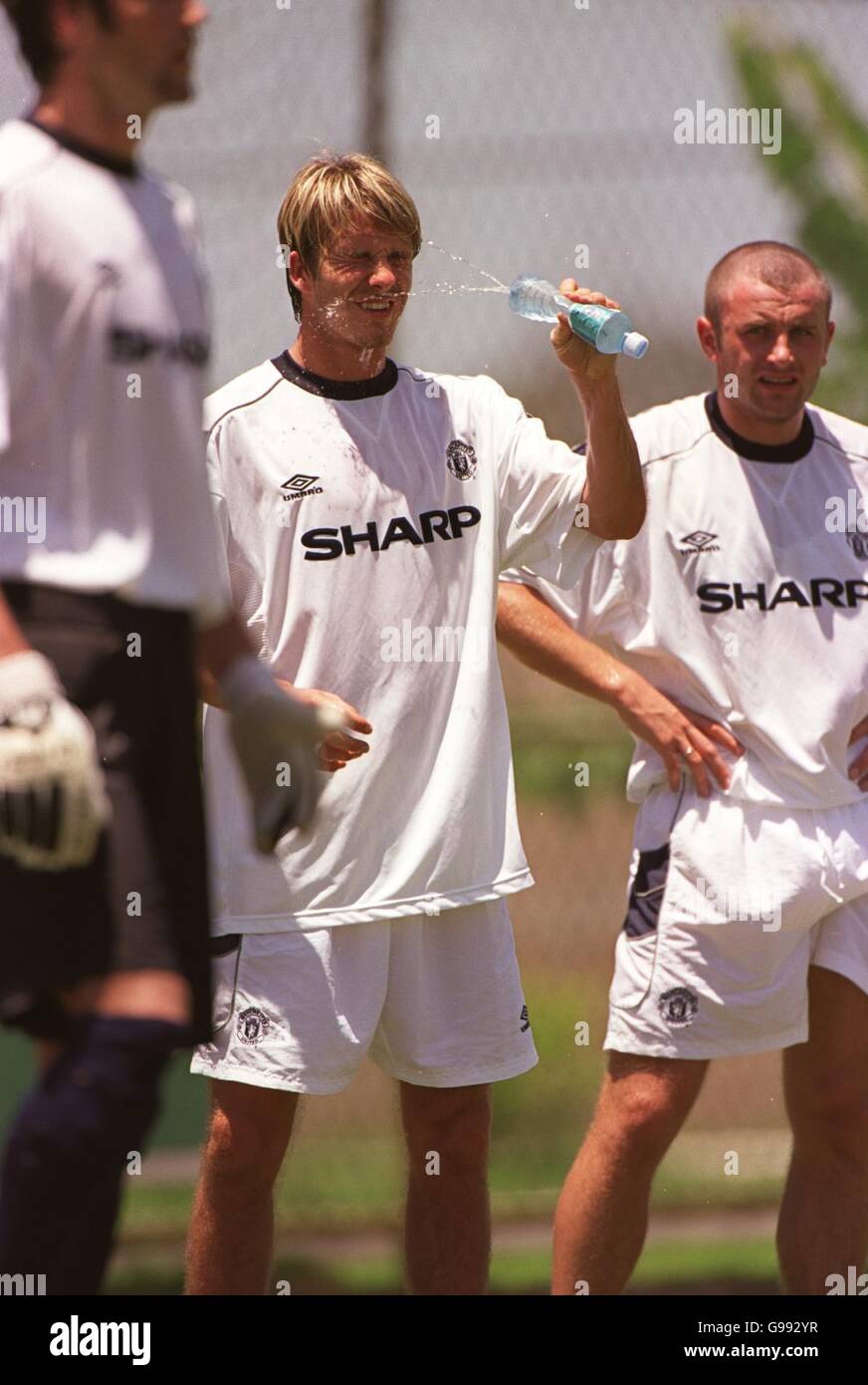 David Beckham of Manchester United cools off in the Rio sun with water ...