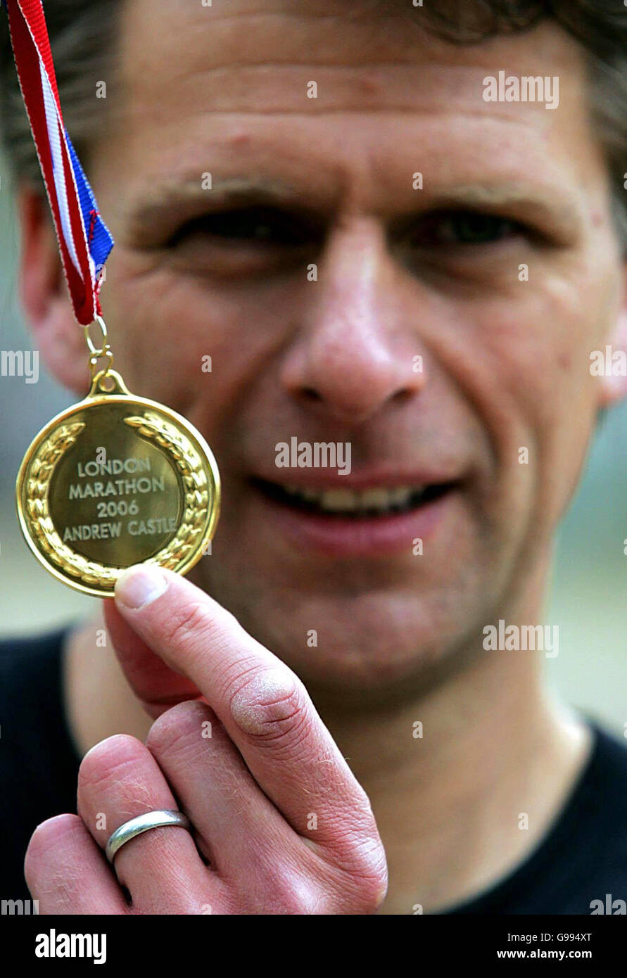 GMTV presenter Andrew Castle holds his medal following his completion ...