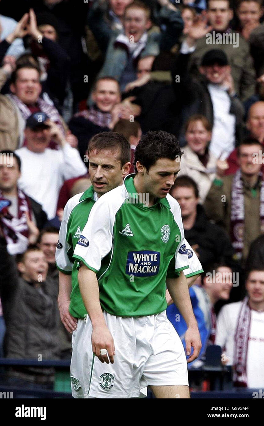 Hibernian Ivan Sproule (R) is sent off watched by team-mate Gary Smith ...
