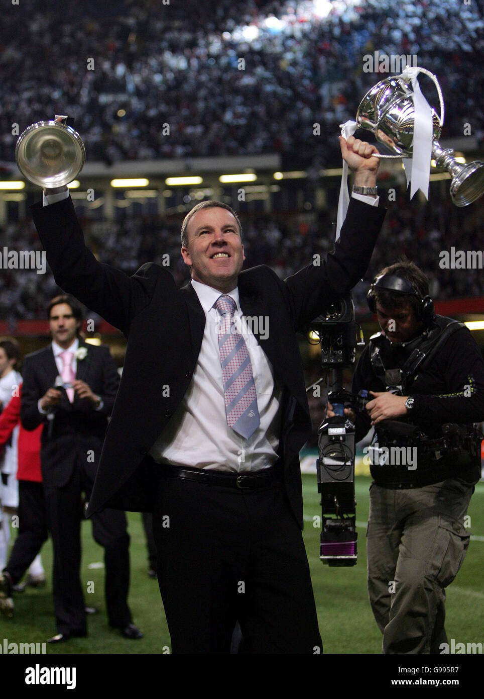 Swansea City manager Kenny Jackett celebrates with the trophy following ...