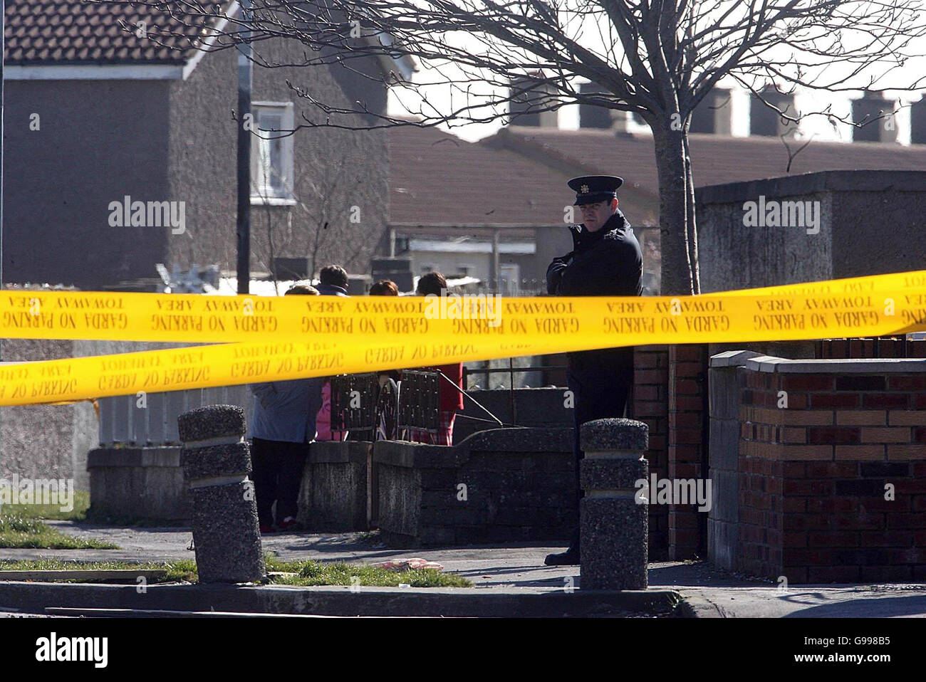 A Garda stands watch at the scene where a man was stabbed to death on ...