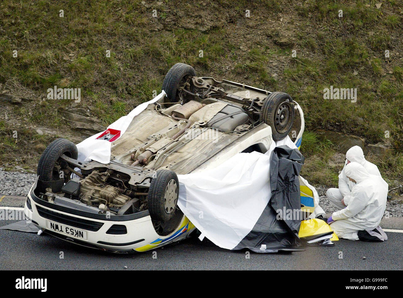 Forensic experts examine the police car which crashed on the A69 near ...