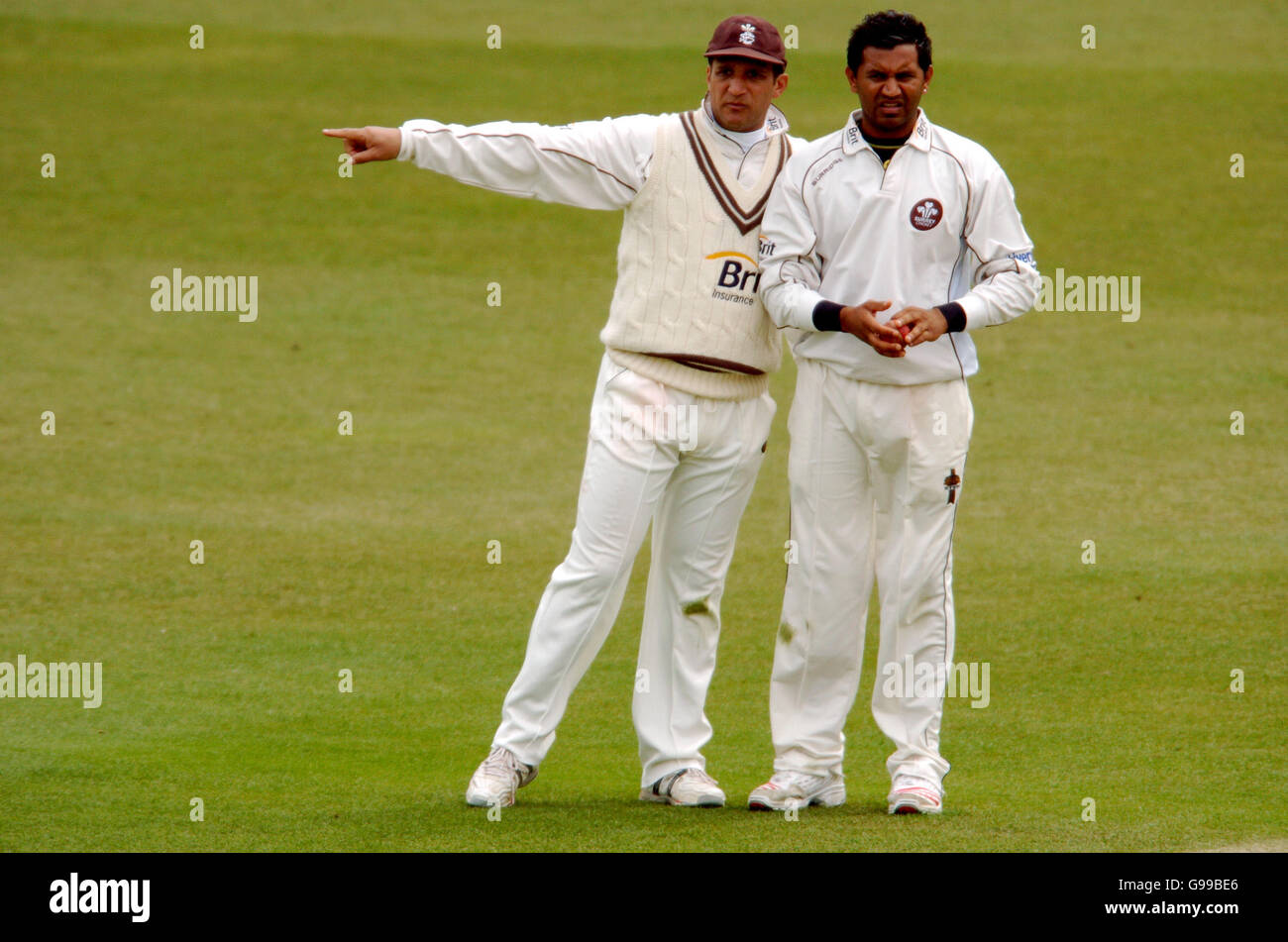 Surrey's Nayan Doshi receives direction from captain Mark Butcher Stock ...
