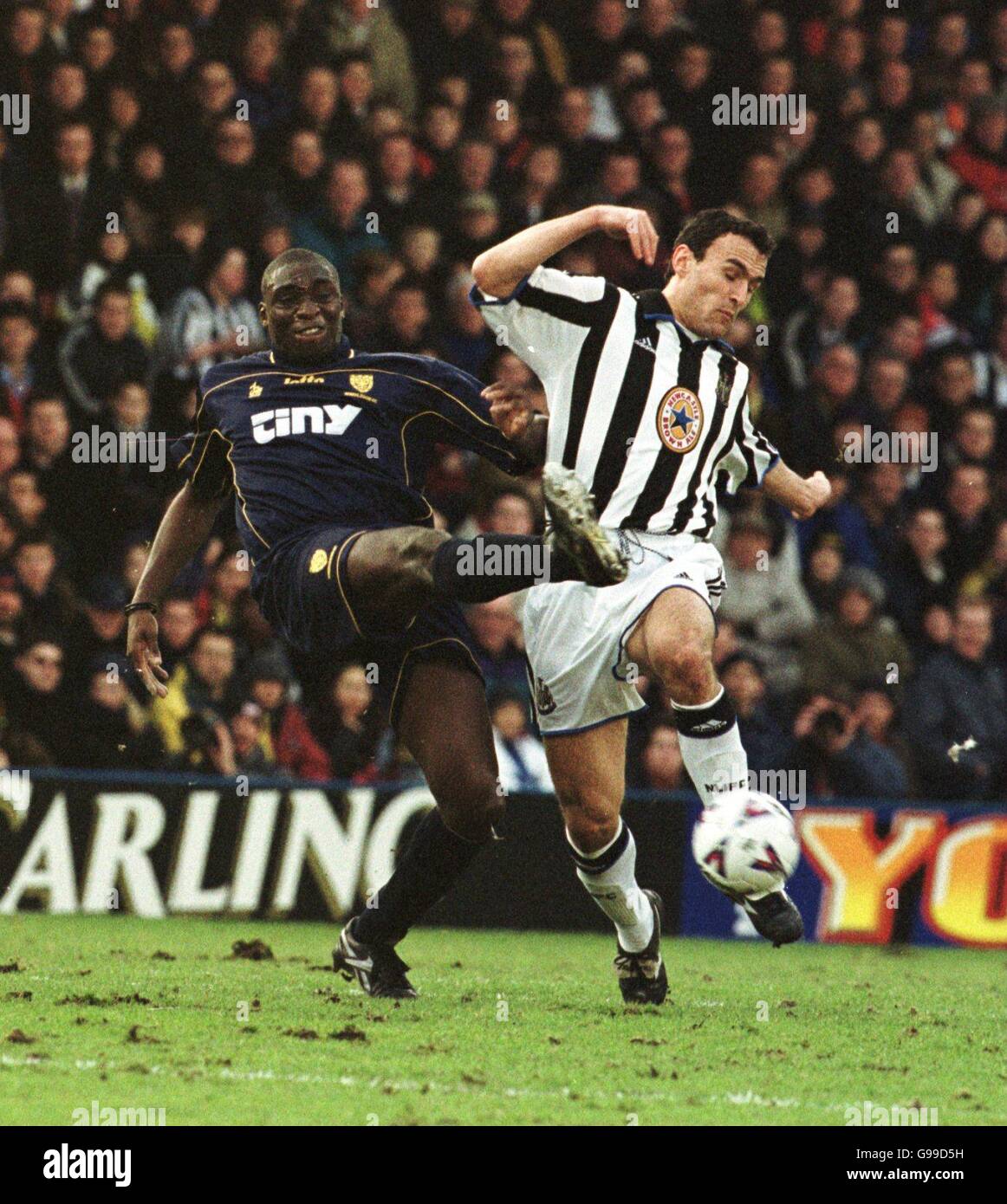 Wimbledon's Carl Leaburn (l) wins the ball from Newcastle United's ...