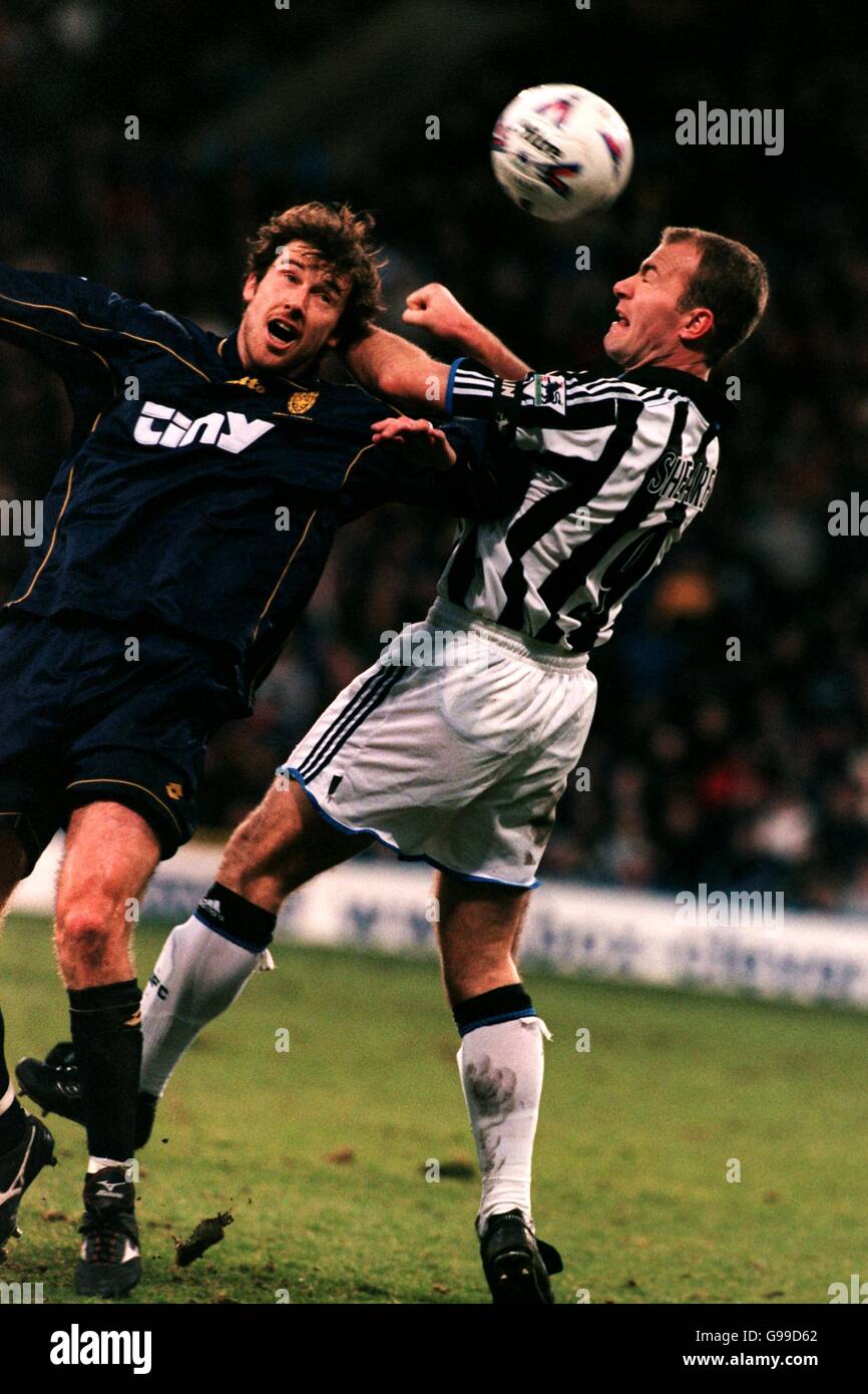 Wimbledon's Kenny Cunningham (l) heads the ball away from Newcastle ...