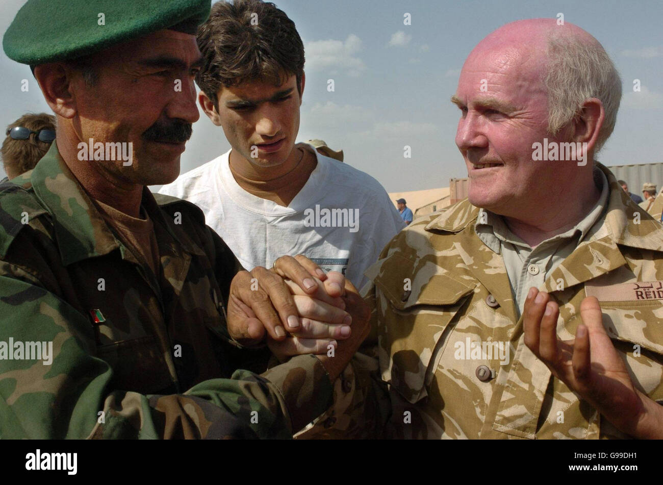 British Defence Secretary John Reid (right) shakes hands with a ...