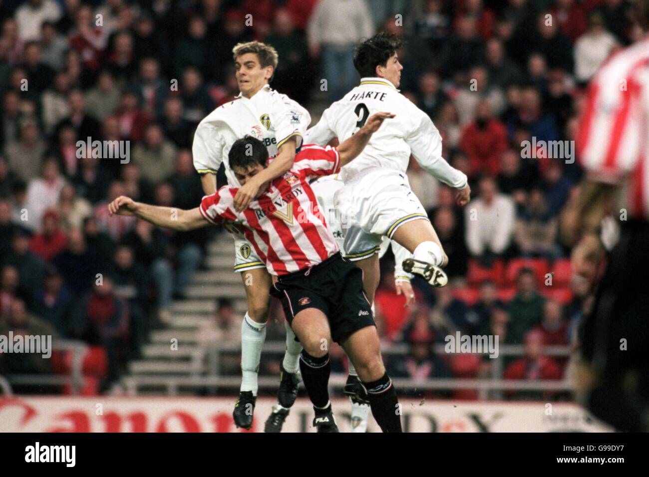 Sunderland's Paul Butler (c) jumps in the air for the ball with Leeds ...