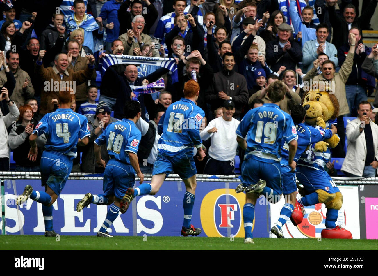 Reading's captain Graeme Murty jumps on the Reading FC mascot Kingsley ...