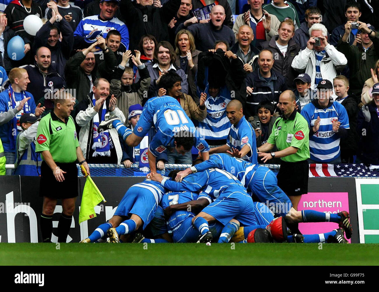 Reading players jump on the Reading FC mascot Kingsley Royal (hidden ...