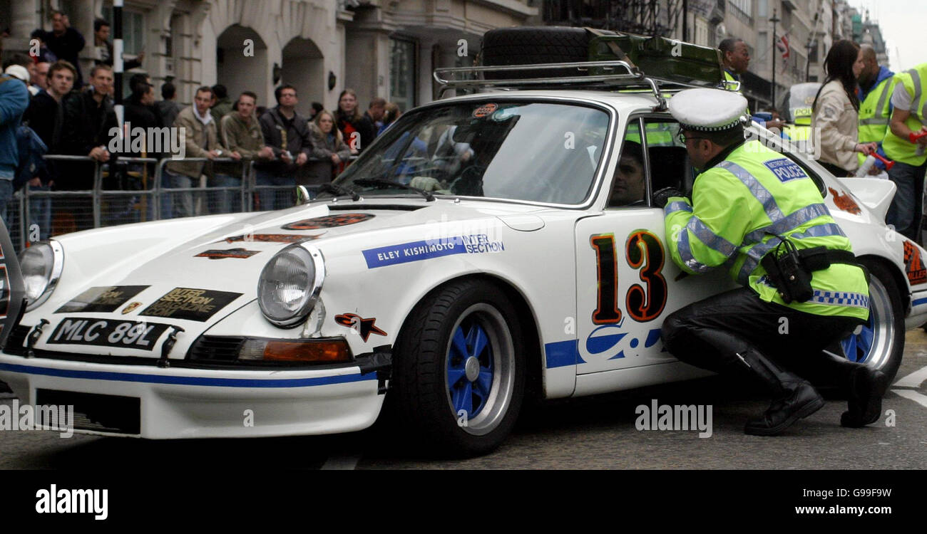 SHOWBIZ Gumball. A policeman talks to a participant at the start of the ...
