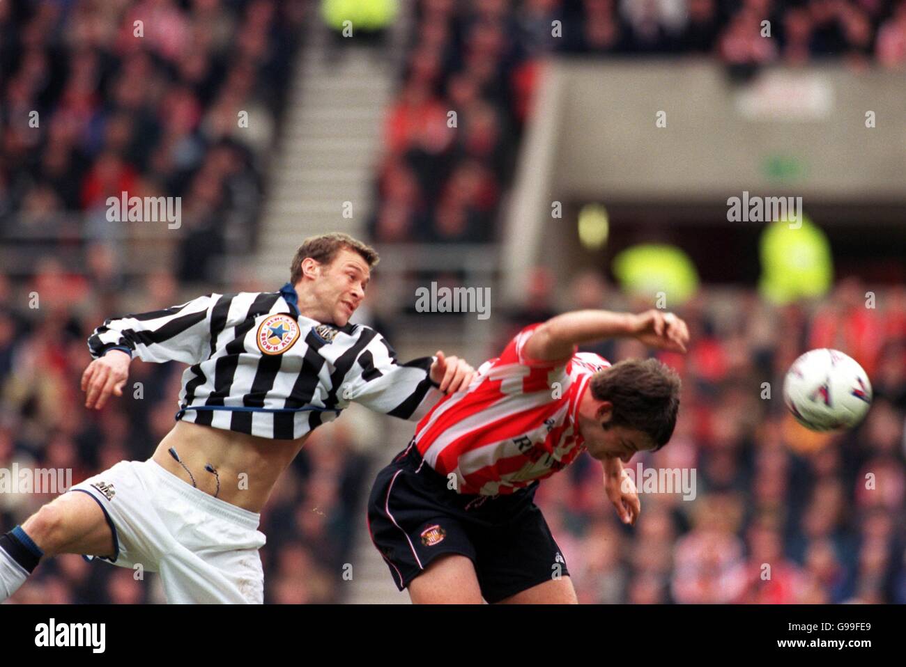 Newcastle United's Duncan Ferguson (l) falls to the floor behind ...