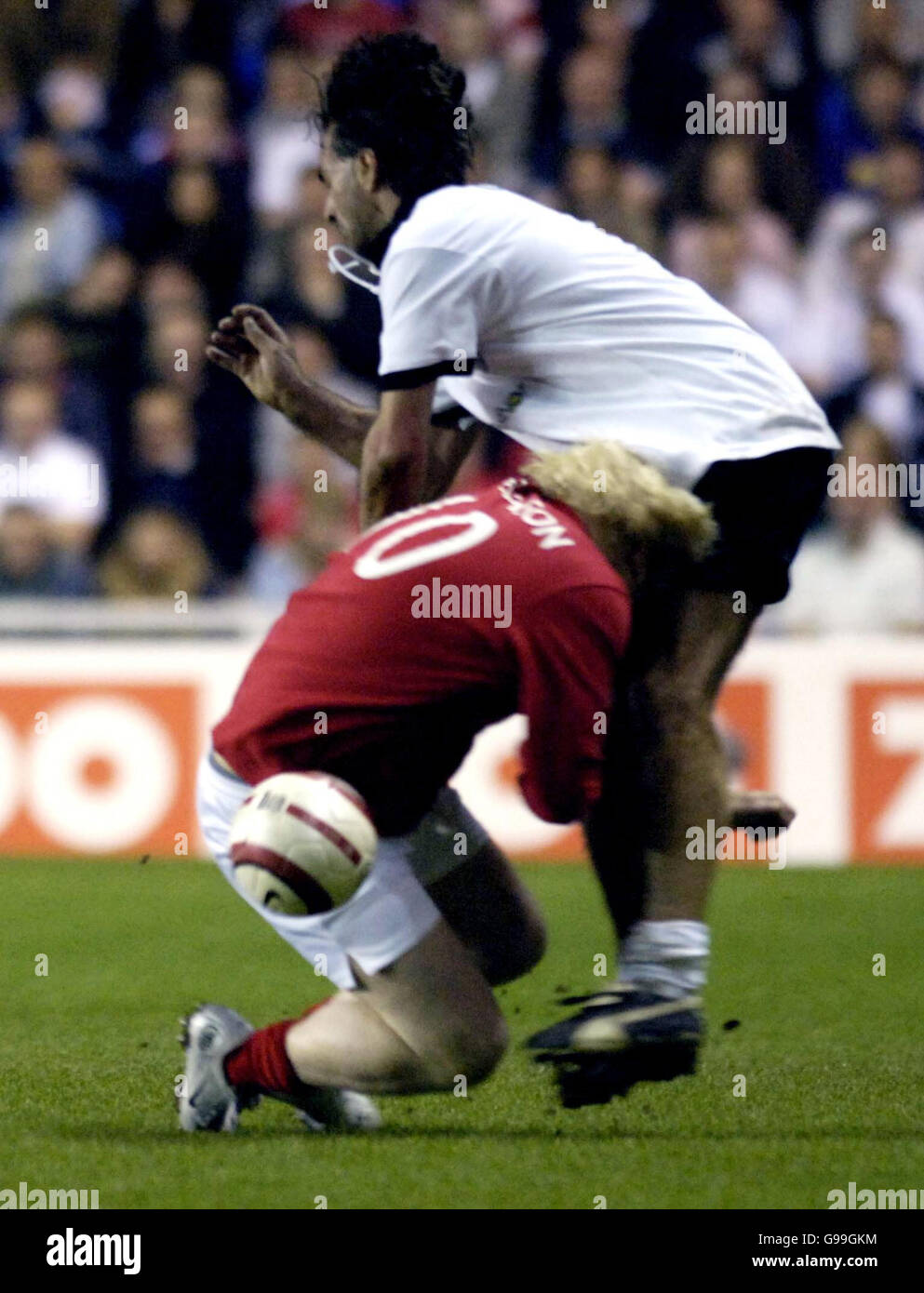 England's Boris Johnson (L) tackles Germany's Maurizio Gaudino during ...