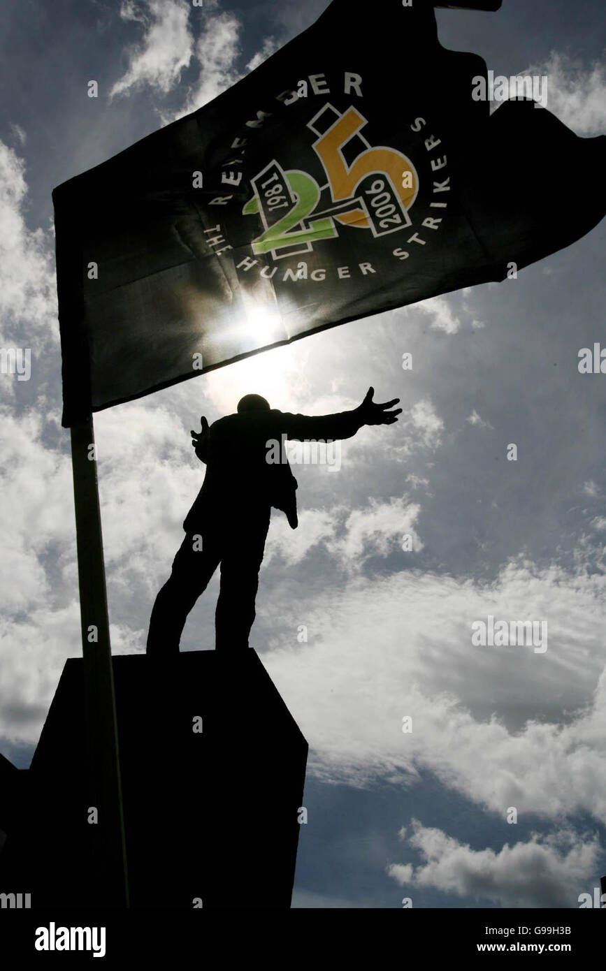A demonstrator waves a flag above a statue of Irish revolutionary James ...