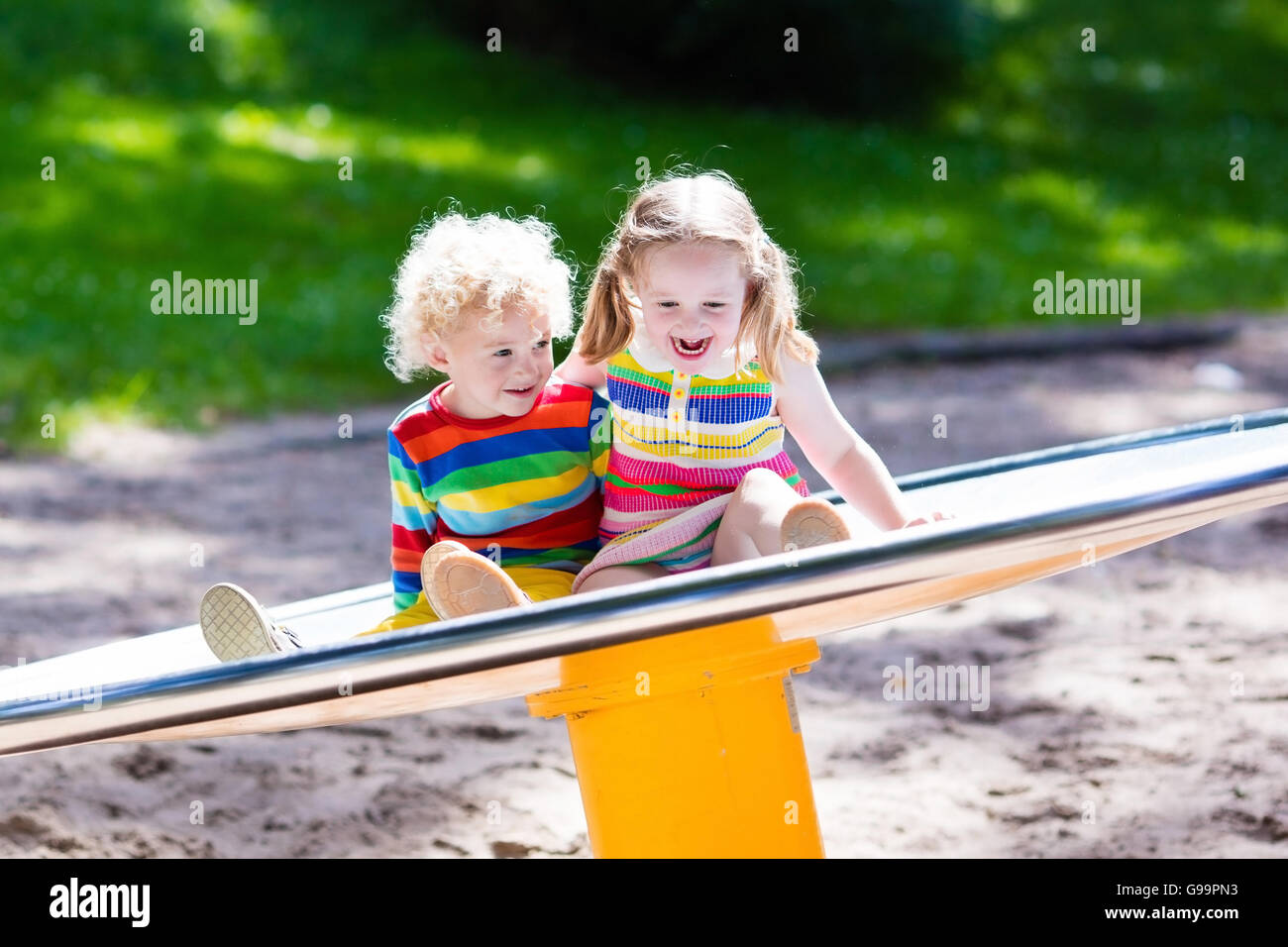 Little boy and girl on a playground. Child playing outdoors in summer ...