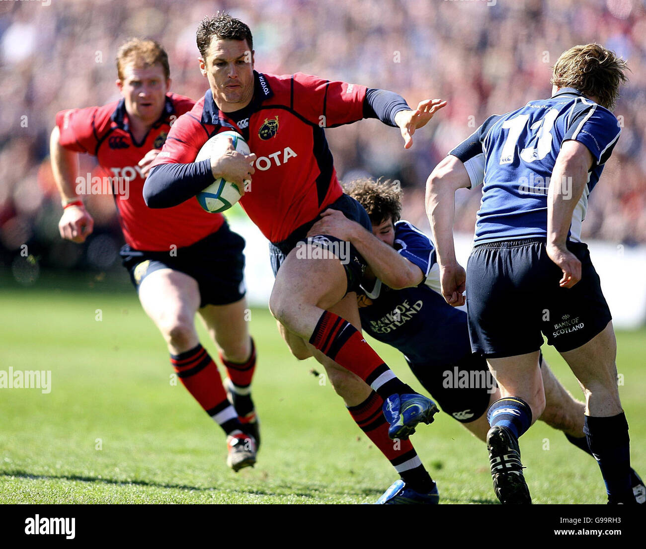 RUGBYU Heineken. Munster's Trevor Halstead is tackled by Leinster's ...