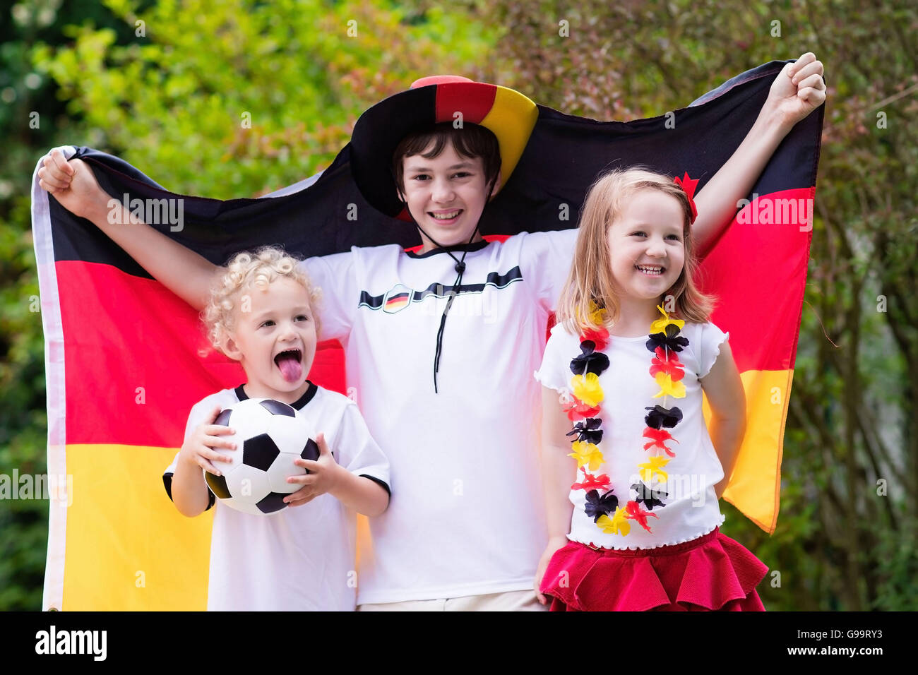 Children cheering and supporting German national football team. Kids ...