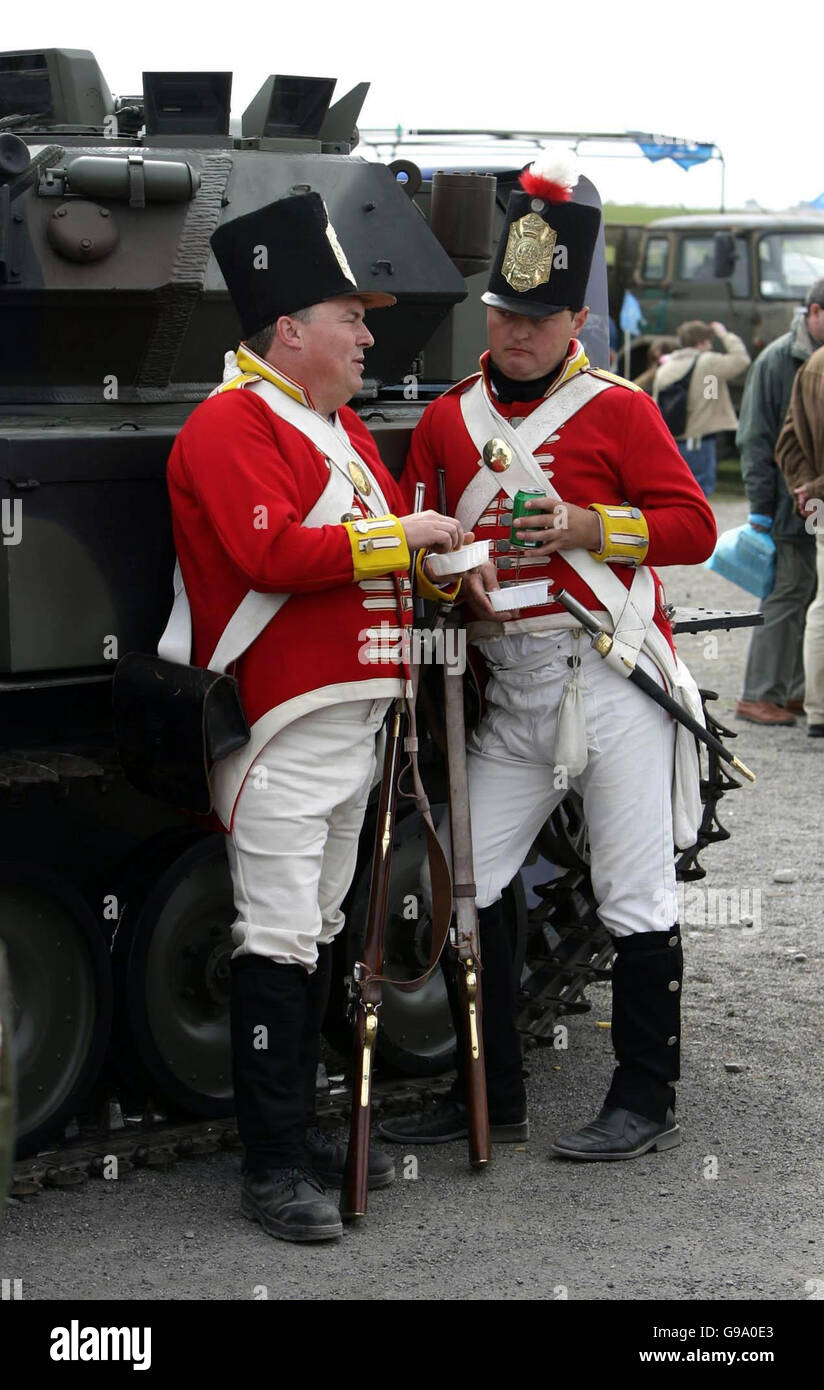 Two members of the Connaught Rangers Reenactment take a break next to ...