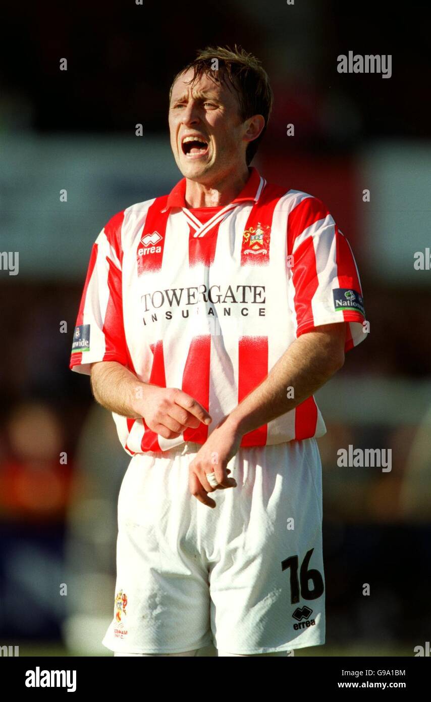 Cheltenham Town's Mark Yates asks the referee how long remains Stock ...