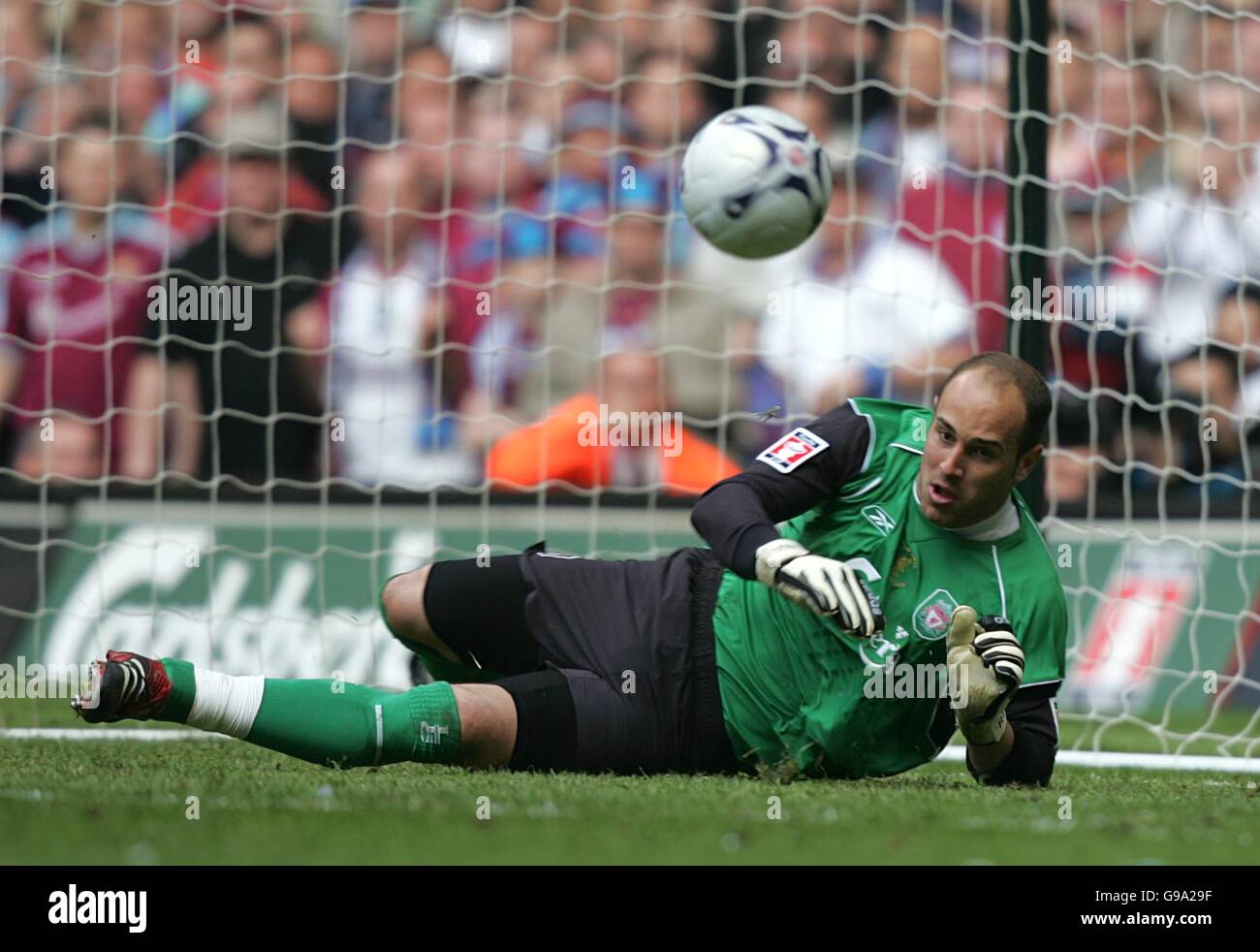 Liverpool's goalkeeper Jose Reina saves from Bobby Zamora during the ...