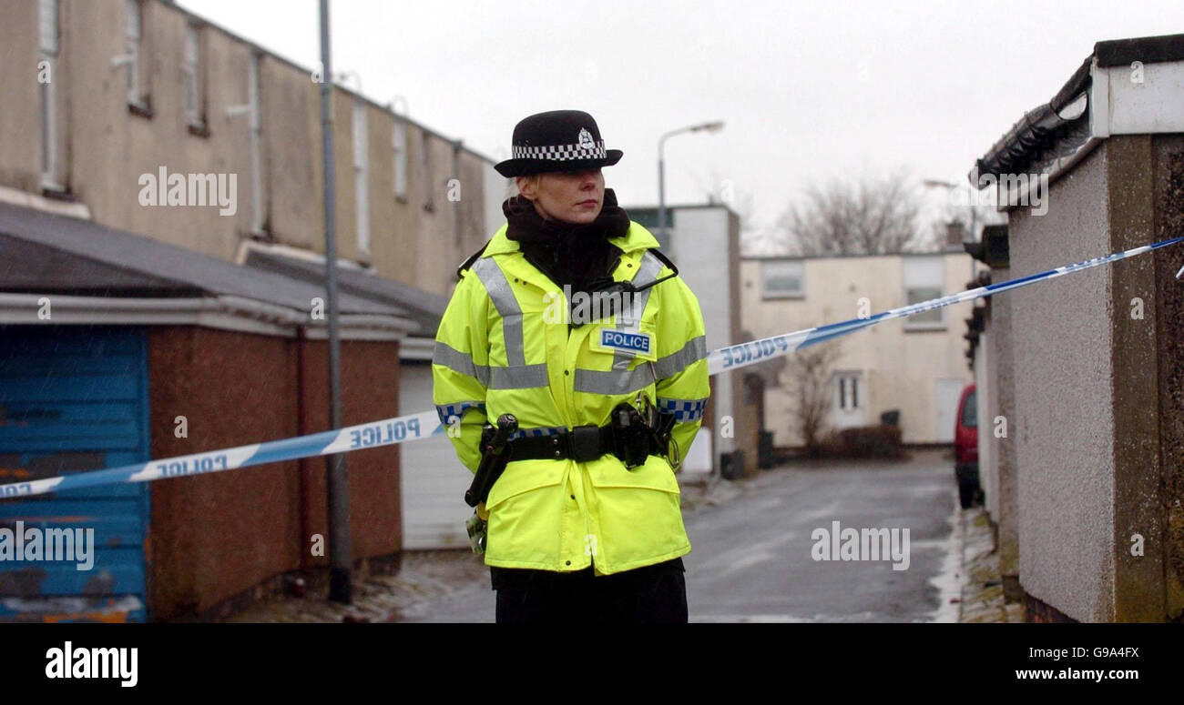 A policewoman stands guard on Torbrex Road, Cumbernauld near Glasgow ...