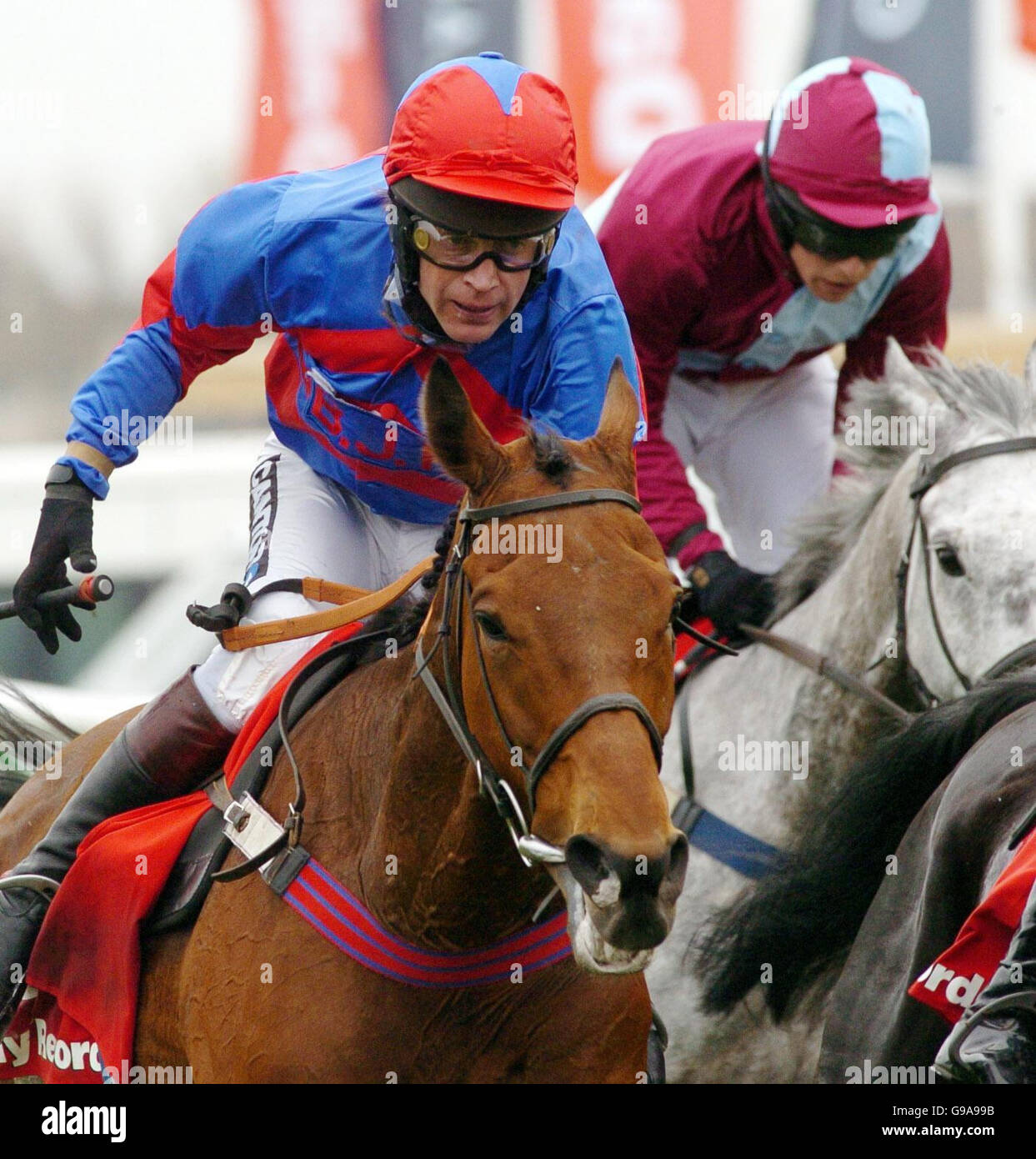 Run For Paddy and jockey Carl Llewellyn (L) leads from Royal Emperor ...