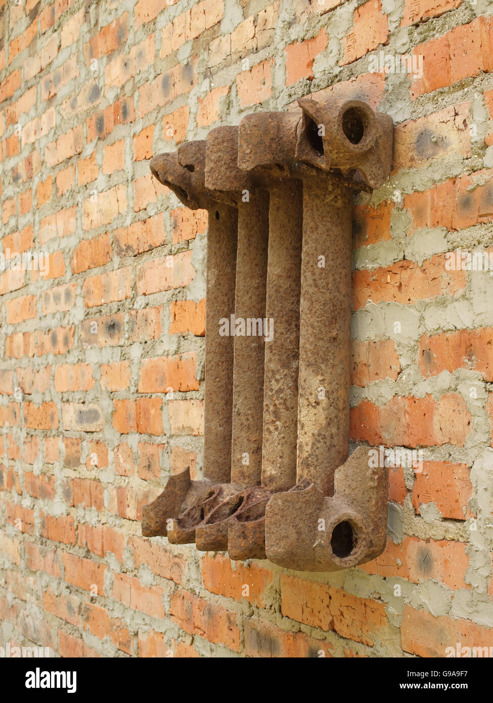 Ruined cast iron radiator for home on a brick wall Stock Photo - Alamy