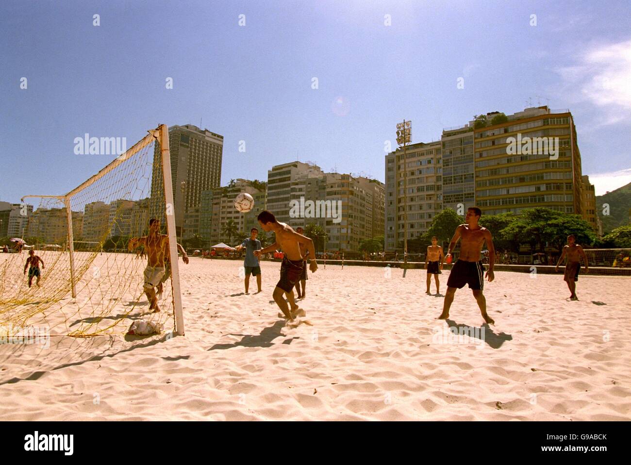 Brazilians playing soccer on copacabana beach hi-res stock photography ...