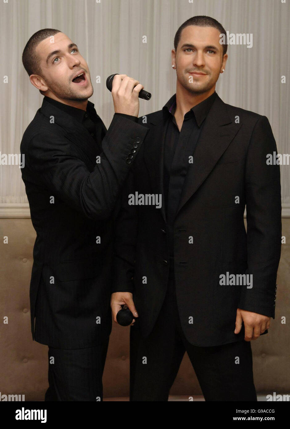 Showbiz tussauds half length mid eye contact smiling black suit hi-res ...