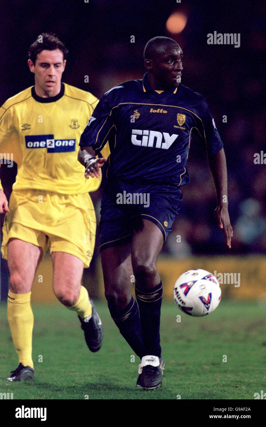 Wimbledon's Carl Leaburn (r) looks up as Everton's David Weir (l) moves ...