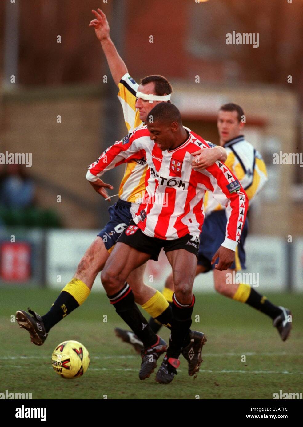 L-R Torquay United's Alec Watson attempts to tackle Lincoln City's ...