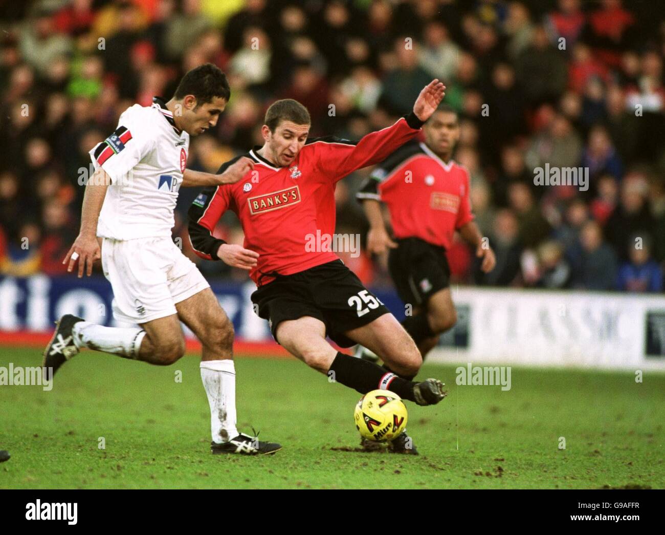 Walsall's Tony Barras (r) clears from Nottingham Forest's Jack Lester ...