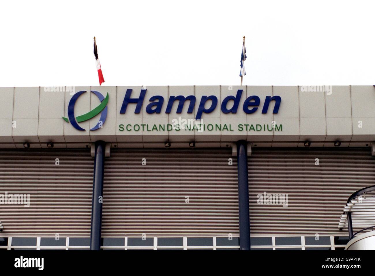 The French and Scottish flags hang limply above a sign on the exterior ...