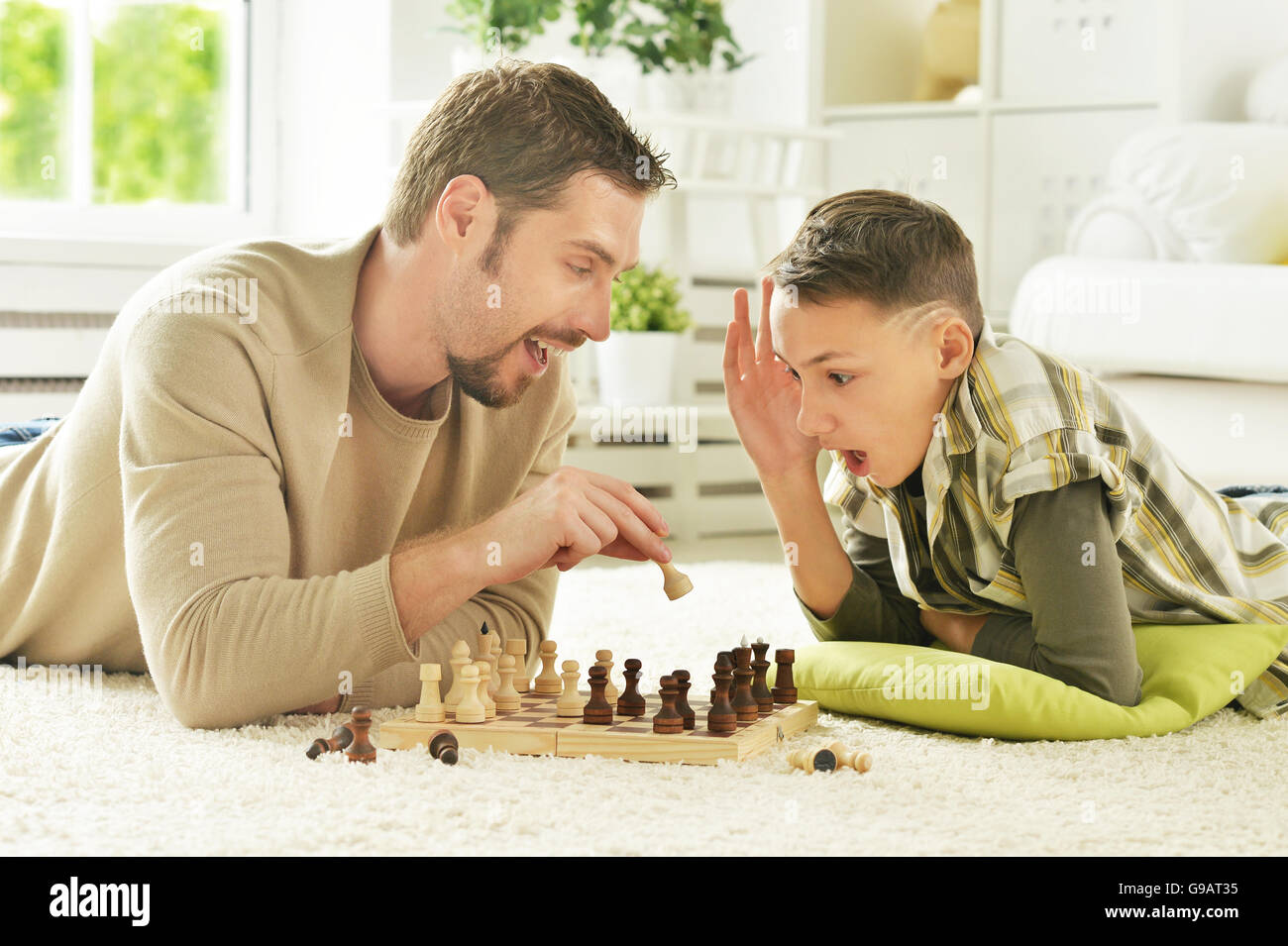 father and son playing chess Stock Photo - Alamy