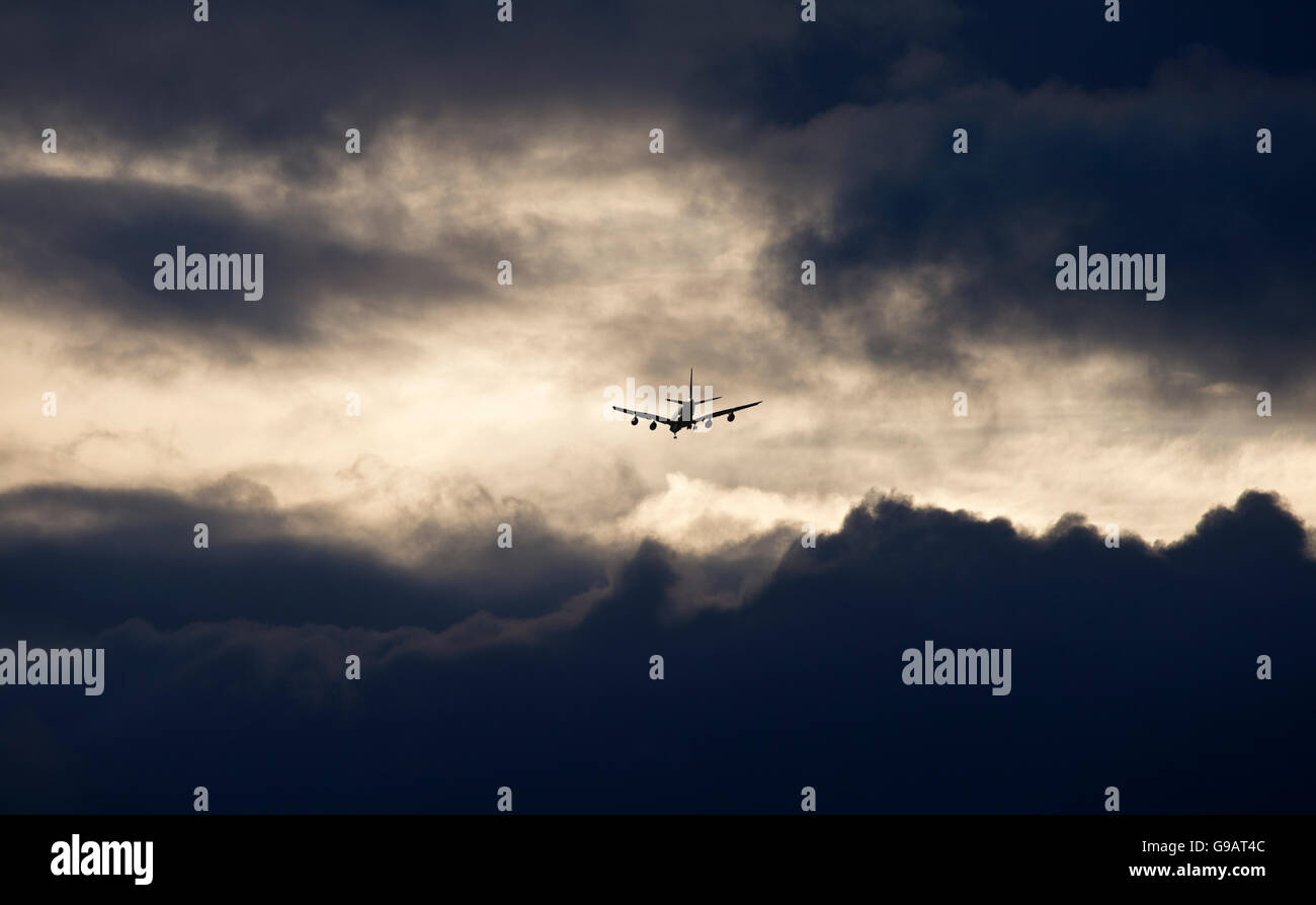 Aircraft flying into sunset at Heathrow airport Stock Photo - Alamy