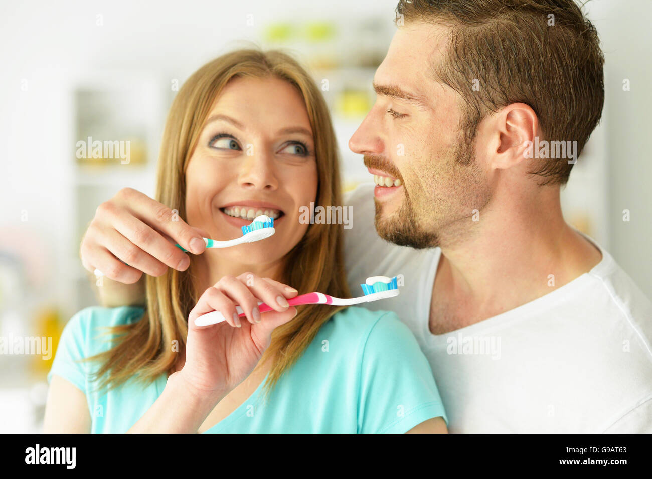 Young couple brushing their teeth Stock Photo - Alamy