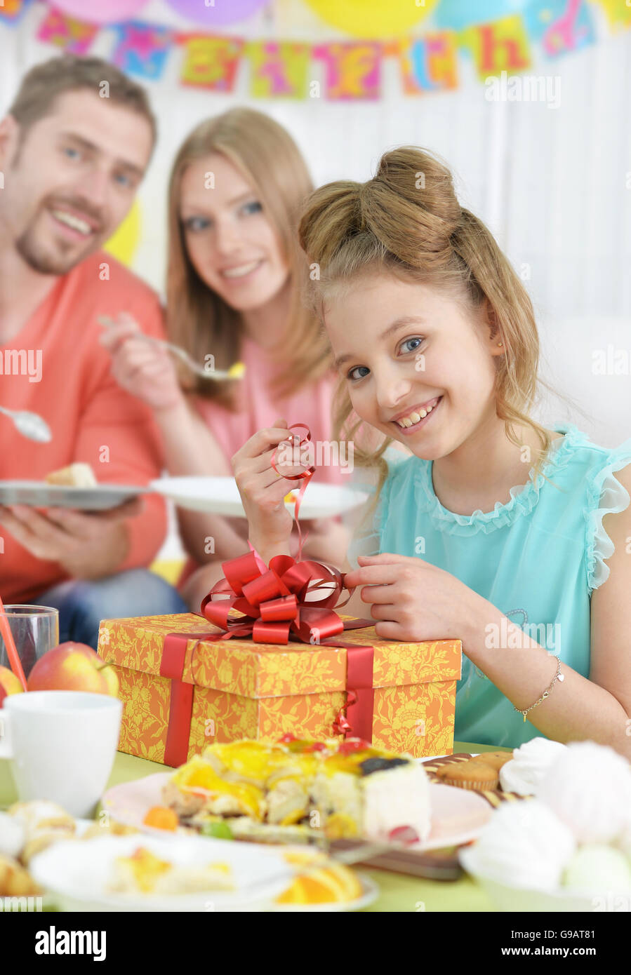 parents and daughter with cake Stock Photo - Alamy