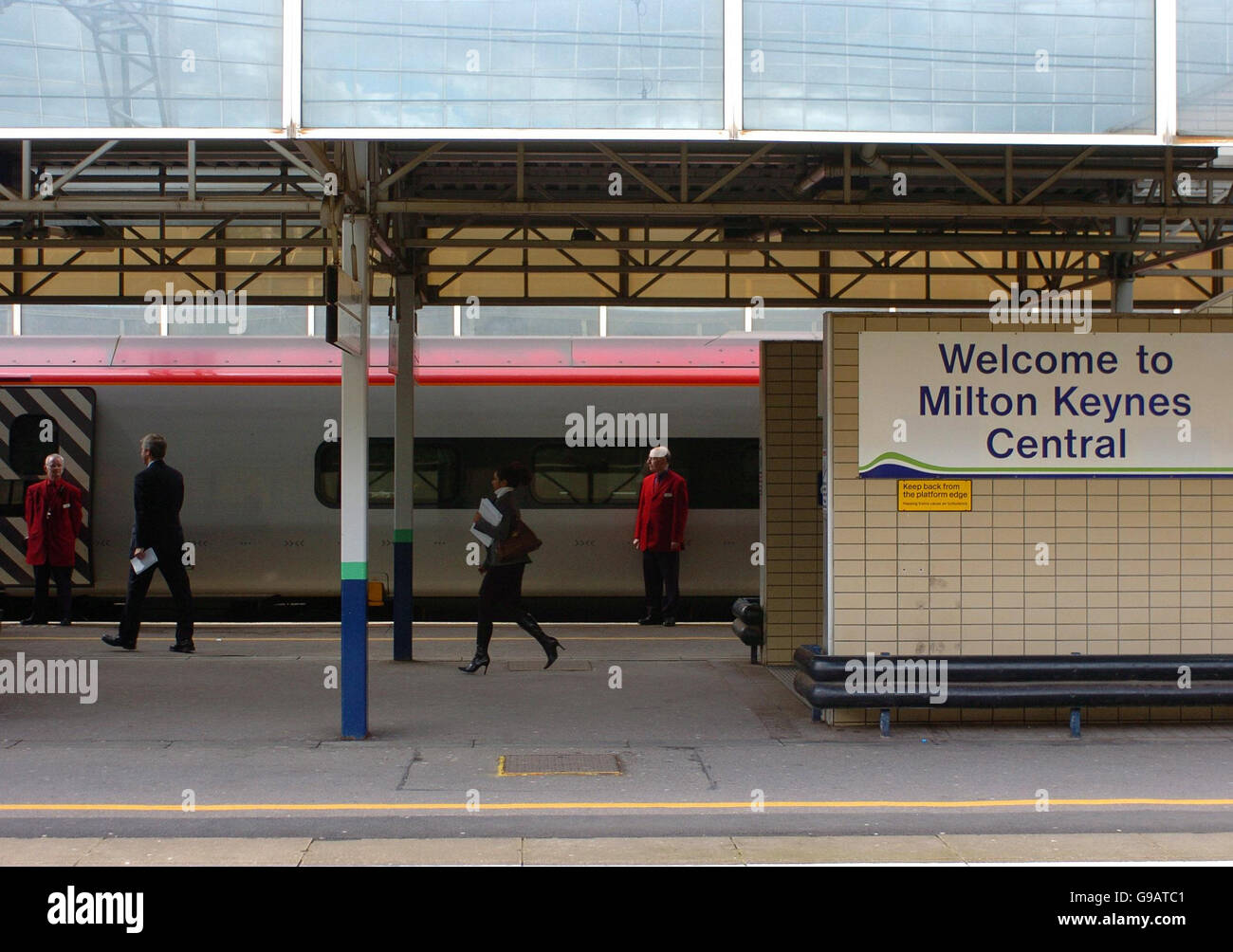 The Rail Minister Derek Twigg (2nd left) prepares to board a Virgin ...