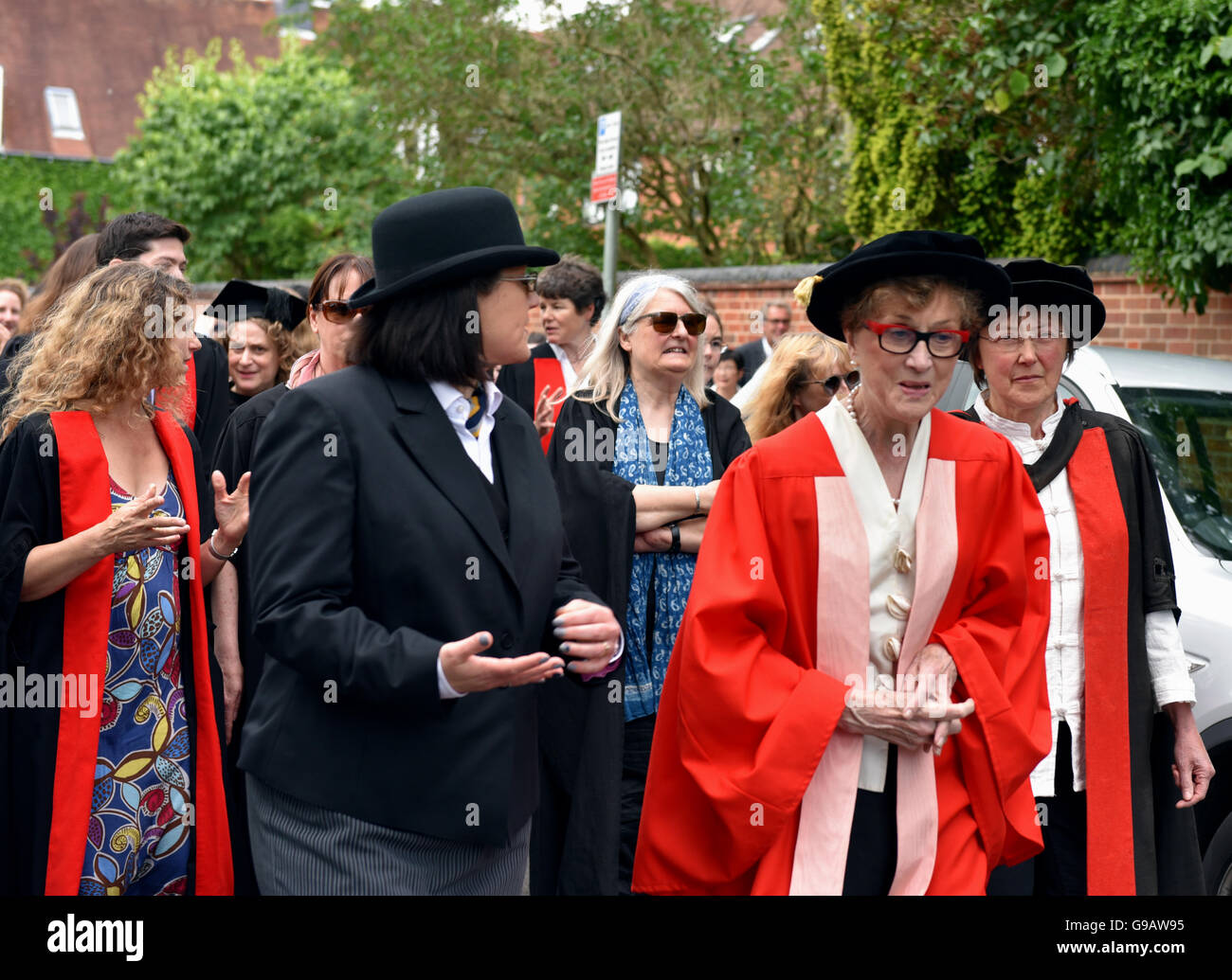A parade of students is lead by professors at Cambridge University ...