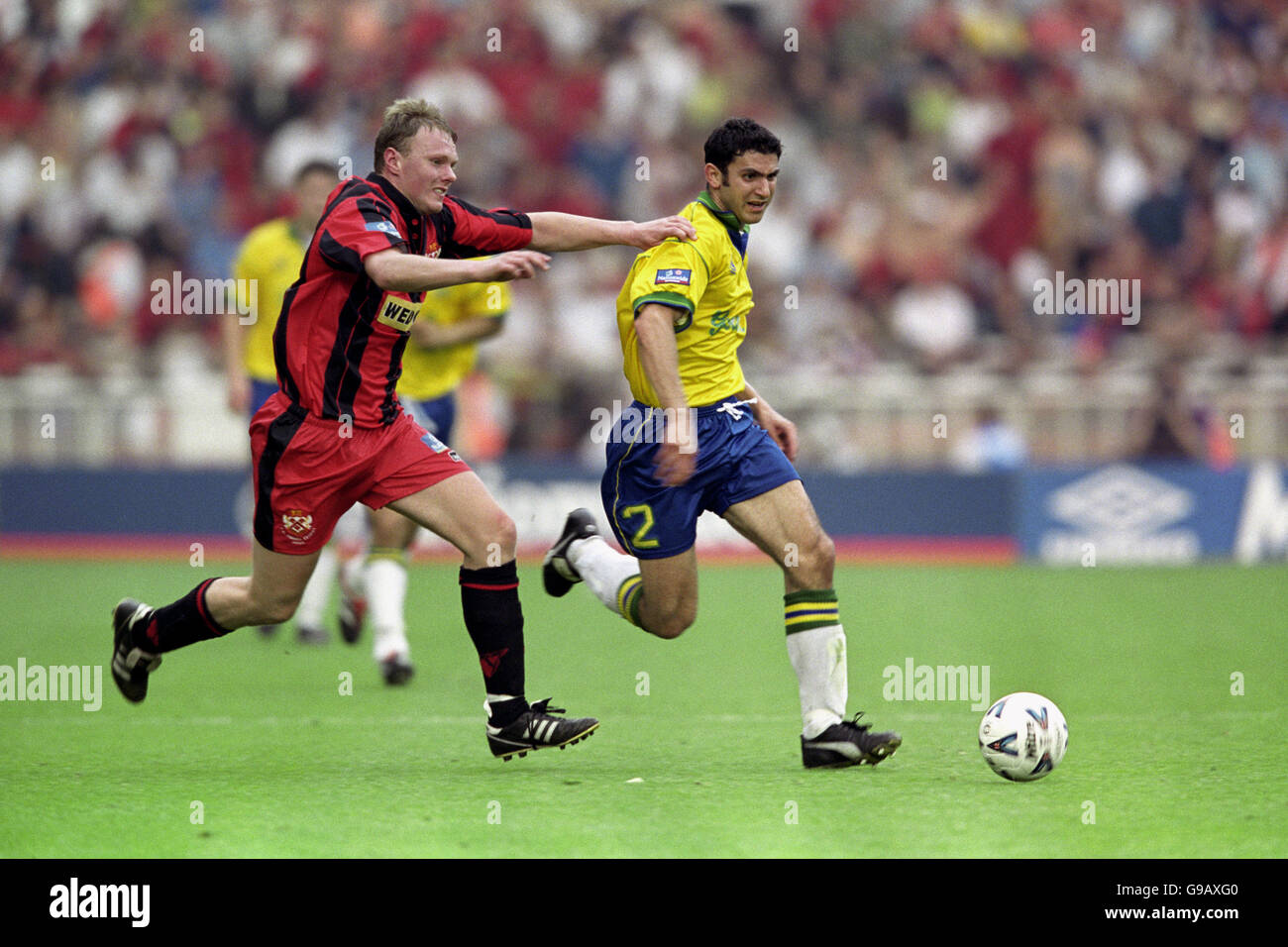 Kingstonian's Tarkan Mustafa (r) gets away from Kettering Town's Gary ...