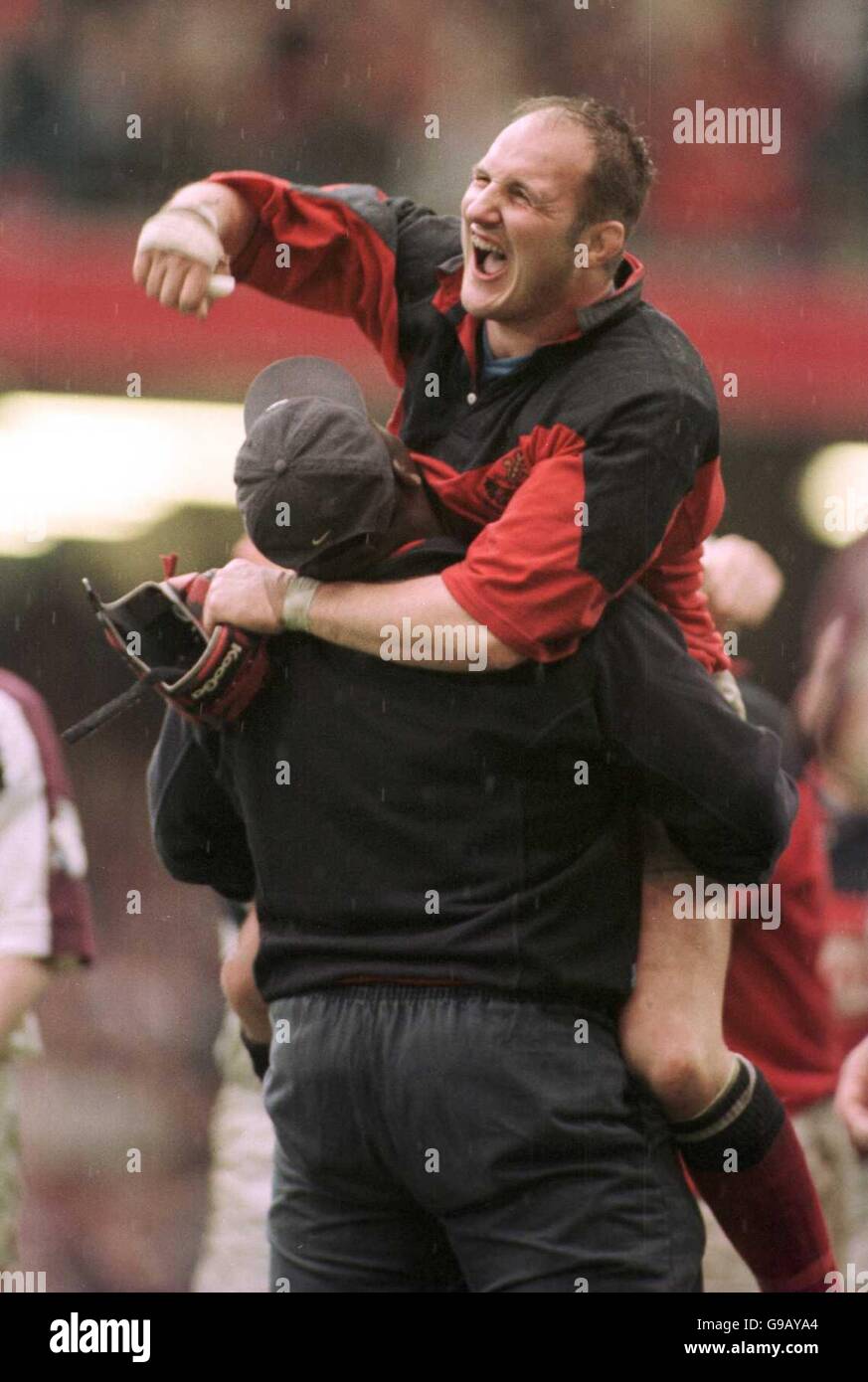 Llanelli's Ian Boobyer jumps onto teammate Martyn Madden to celebrate ...