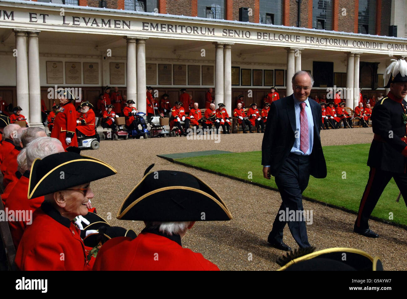 Michael Howard walks past the Chelsea Pensioners before they meet Queen ...