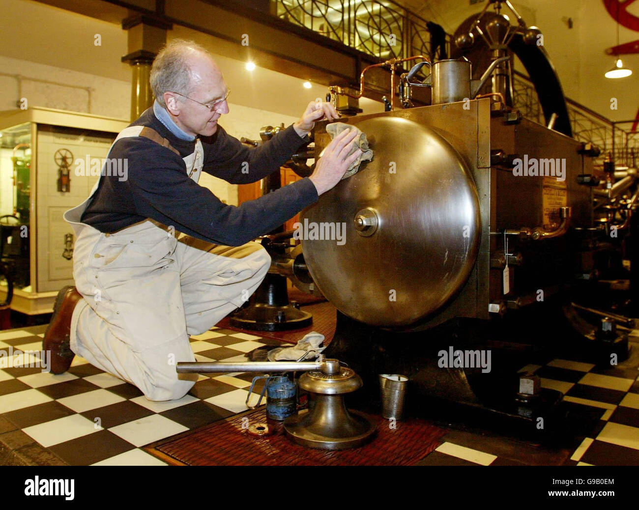 Painter Alan Roberts polishes an 1889 Corliss Horizontal Steam Engine ...