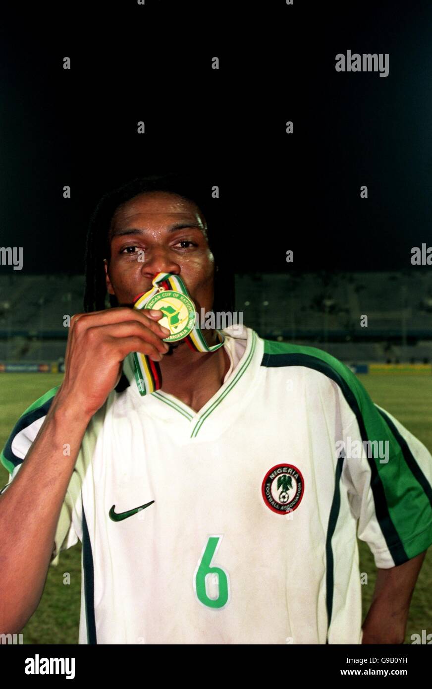 Cameroon captain Rigobert Song kisses his gold medal to celebrate ...