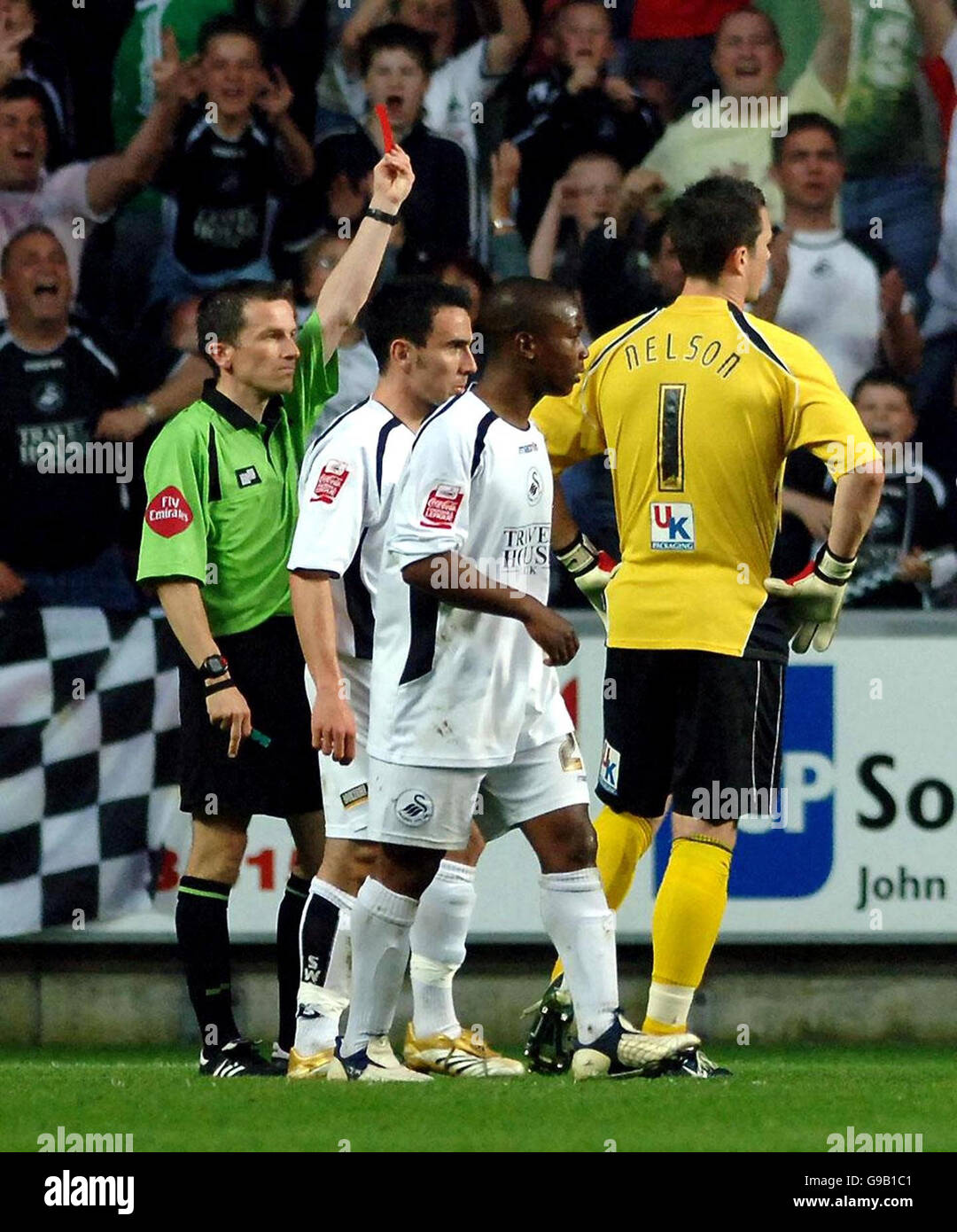 Brentford's Stuart Nelson (R) is sent off by referee Keith Stroud (L ...