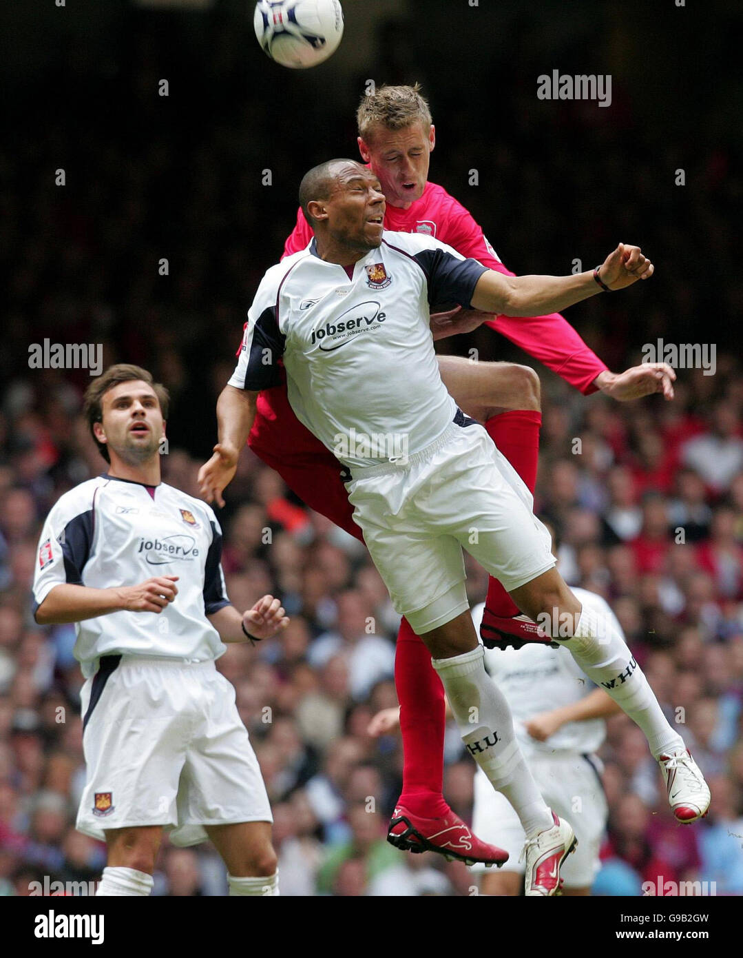 Liverpool's Peter Crouch jumps for the ball with West Ham's Danny ...