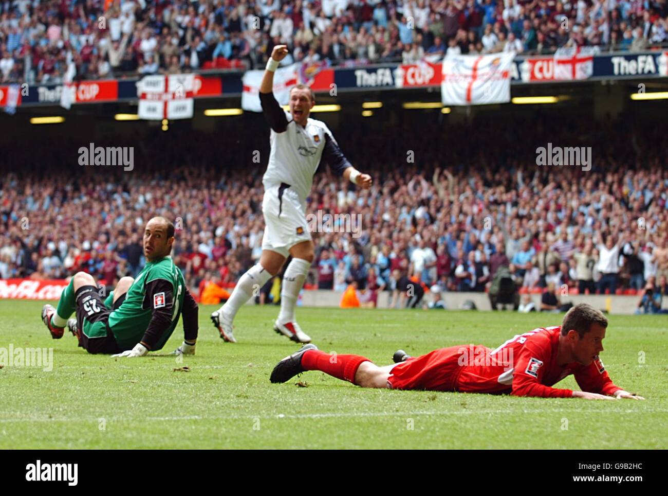 West Ham United's Dean Ashton celebrates as Liverpool's Jamie Carragher ...