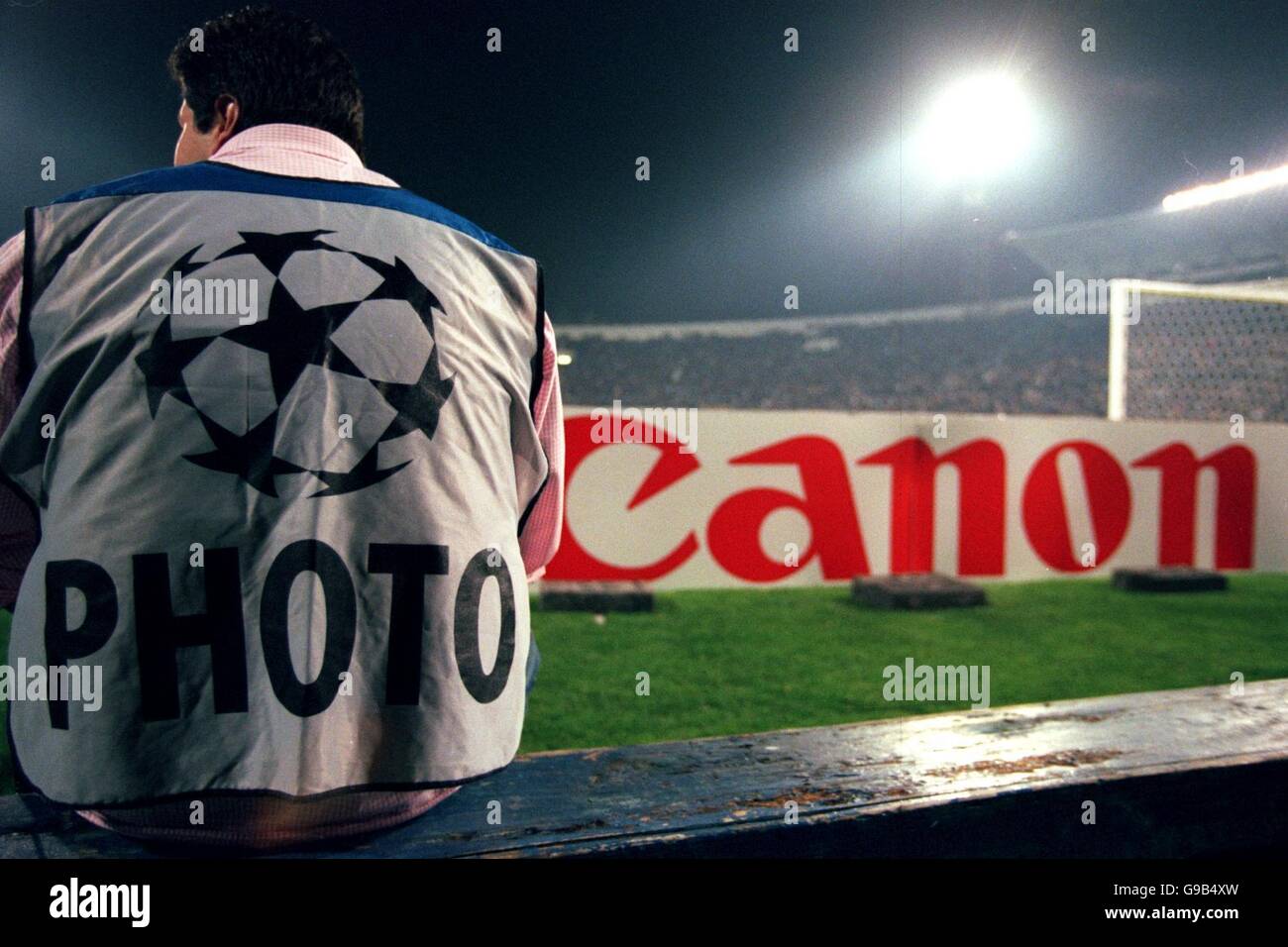 A photographer wearing an official Champions League bib Stock Photo - Alamy
