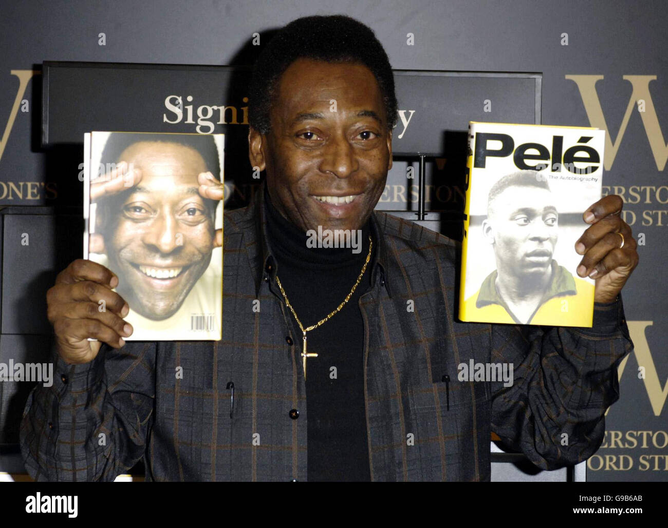 Brazilian football legend Pele holds a copy of his new autobiography ...